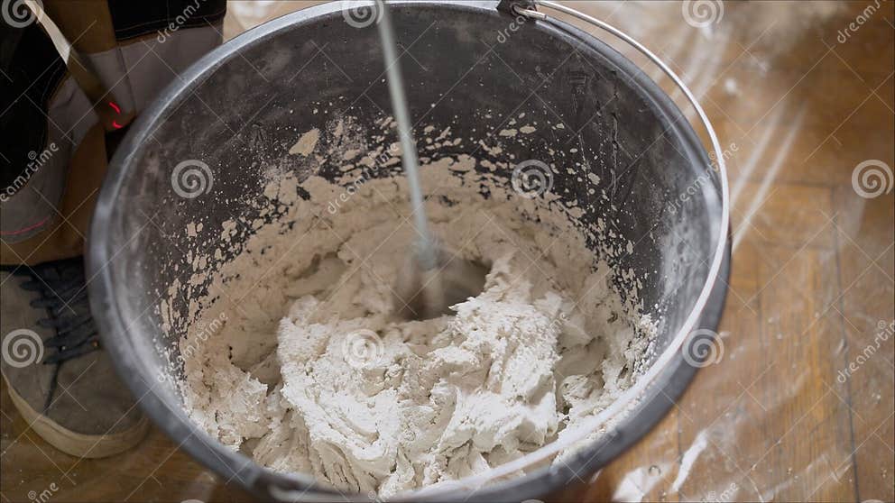 Stir the Building Mix in a Bucket. Stirs the Solution in a Bucket Stock ...