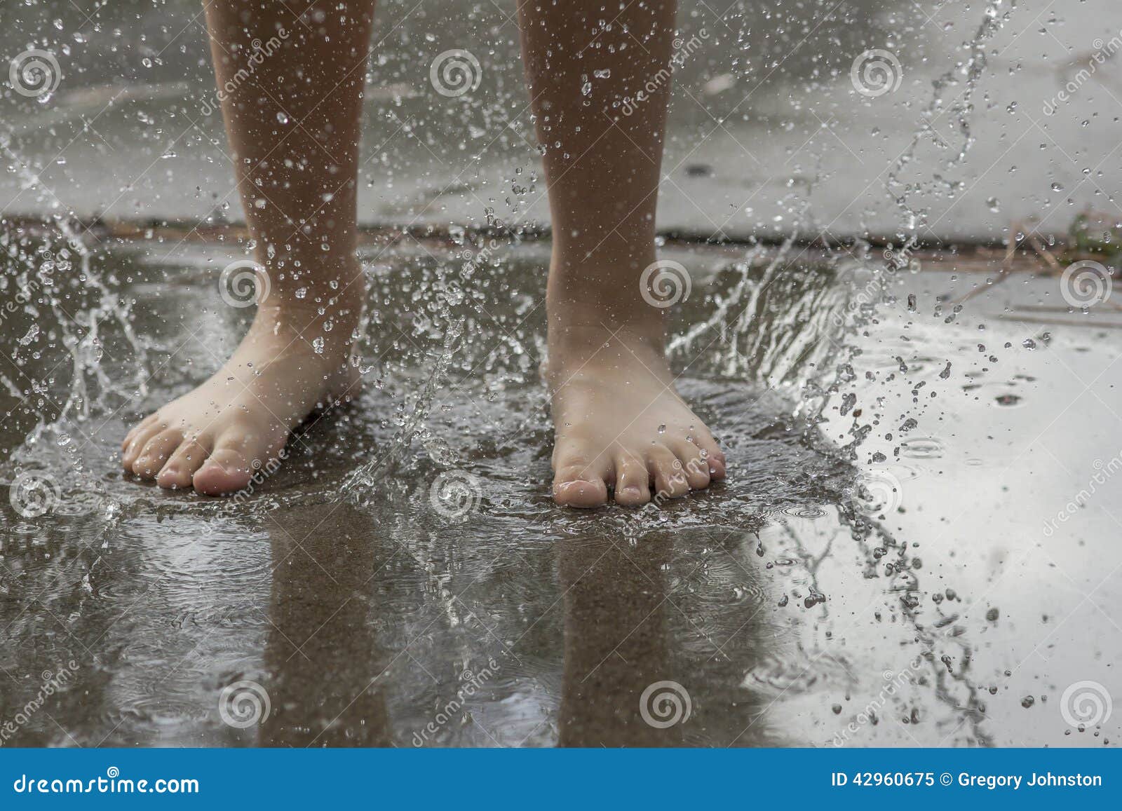 Child Stomping In A Puddle With His Foot Stock Photography ...