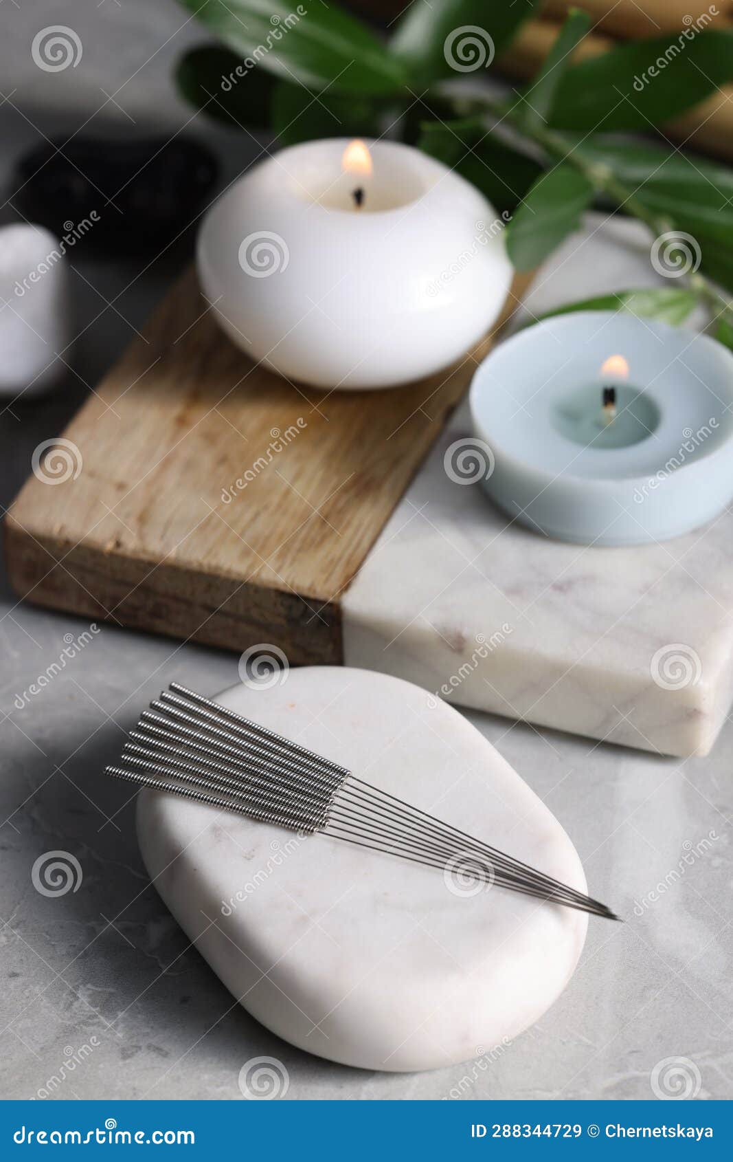 Stone with Acupuncture Needles on Light Grey Marble Table Stock Image ...