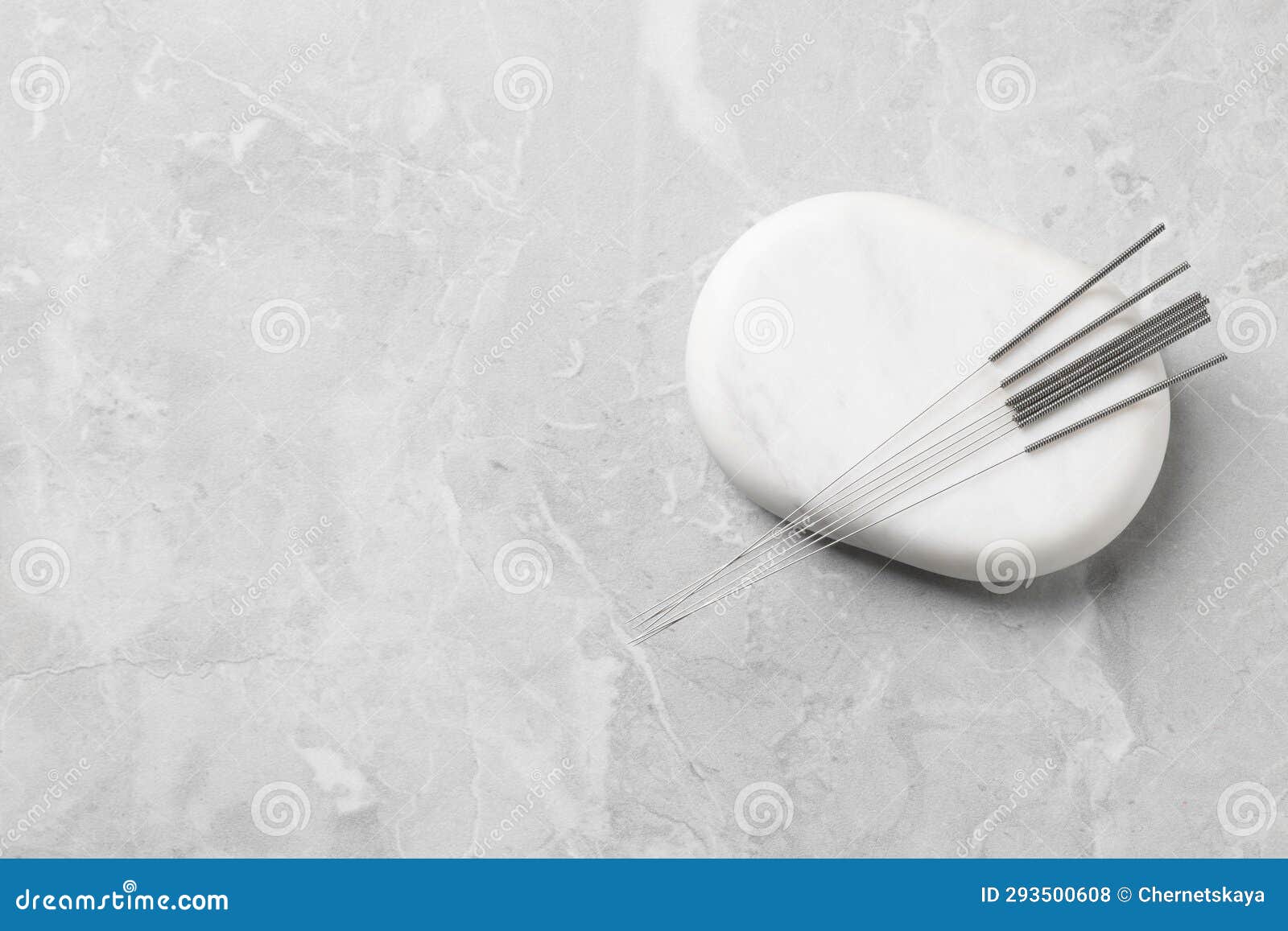 Stone with Acupuncture Needles on Light Grey Marble Table, Top View ...
