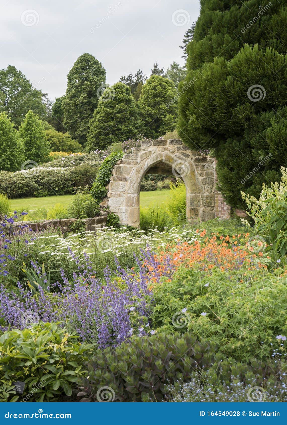 Ancient Stone Arch in a Garden Stock Photo - Image of britain, flowers ...
