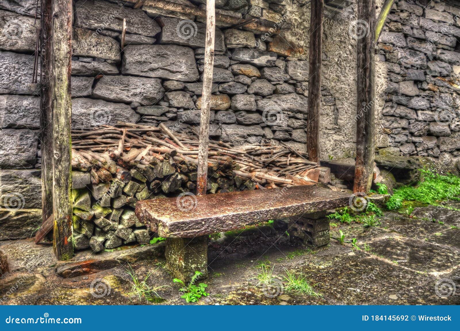 Stone Bench Near a Pile of Firewood in the Backyard Stock Photo - Image ...