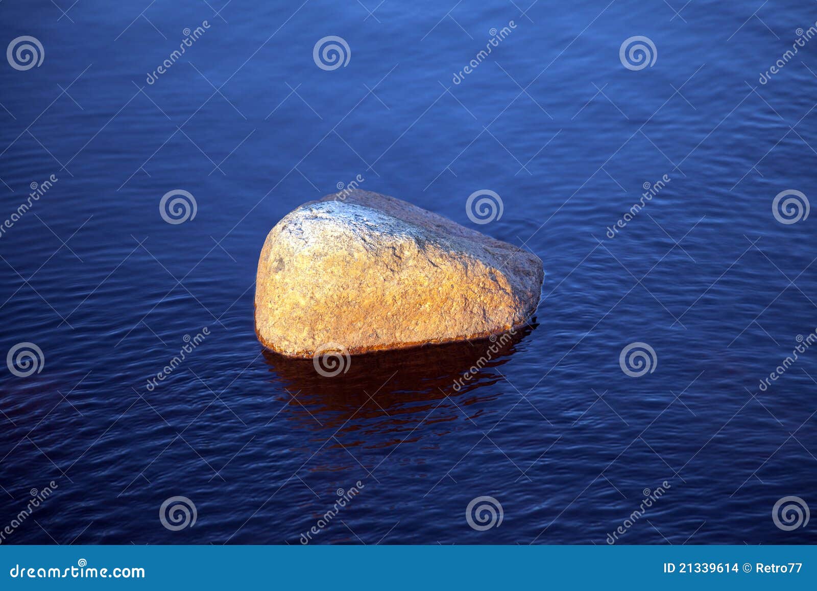 Stone on blue water stock photo. Image of water, stone - 21339614