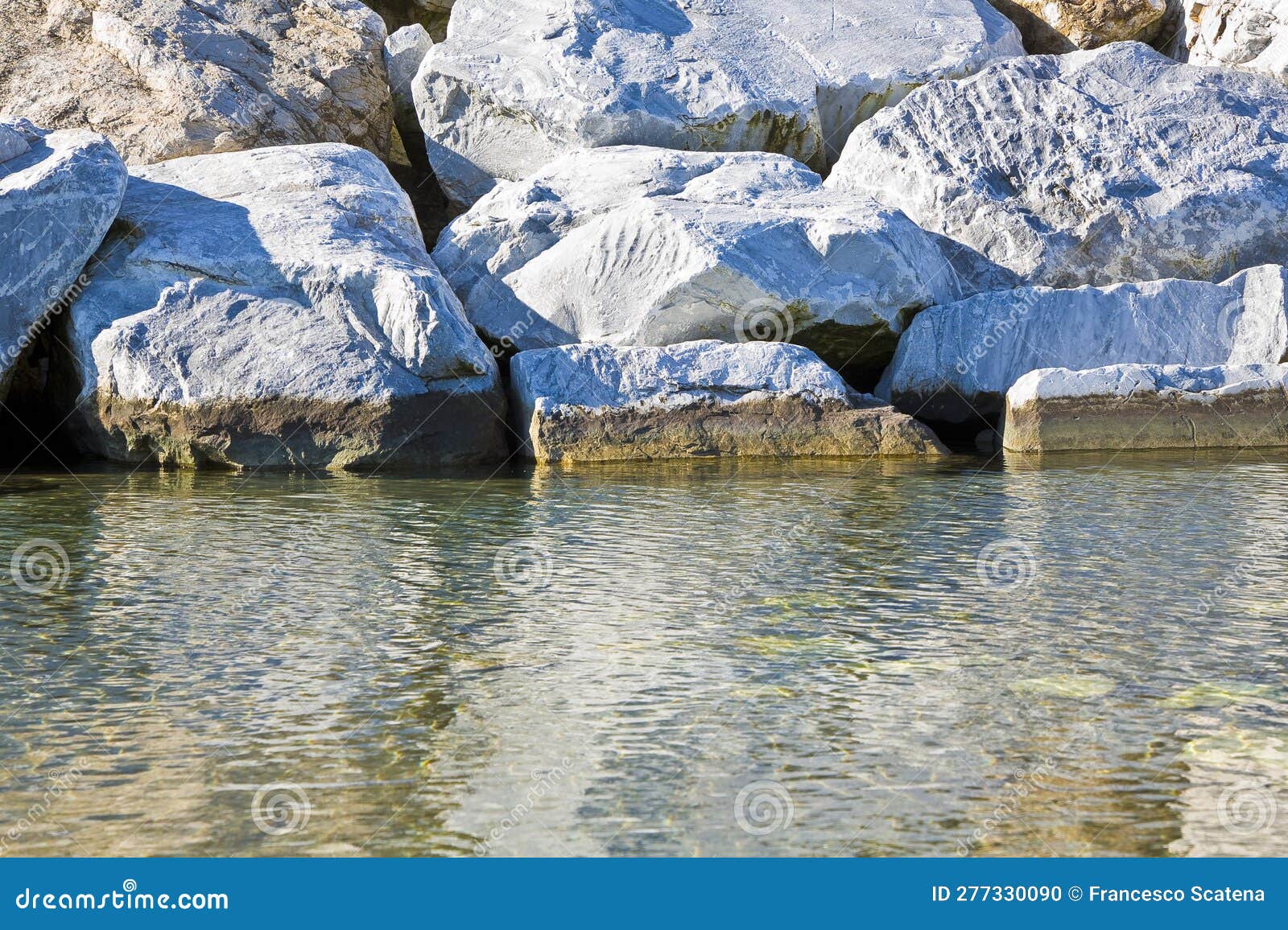 Stone Breakwater Rocks are Reflected in the Water Stock Photo - Image ...