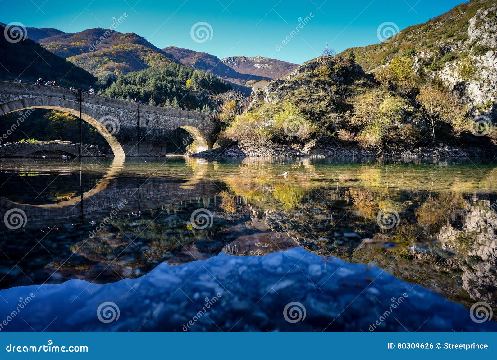 A stone bridge on the lake stock photo. Image of lake - 80309626