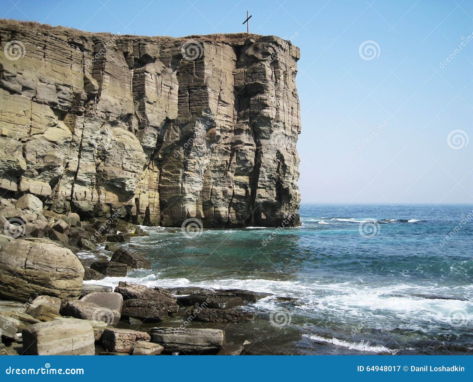 A stone cliff in the sea stock image. Image of water - 64948017
