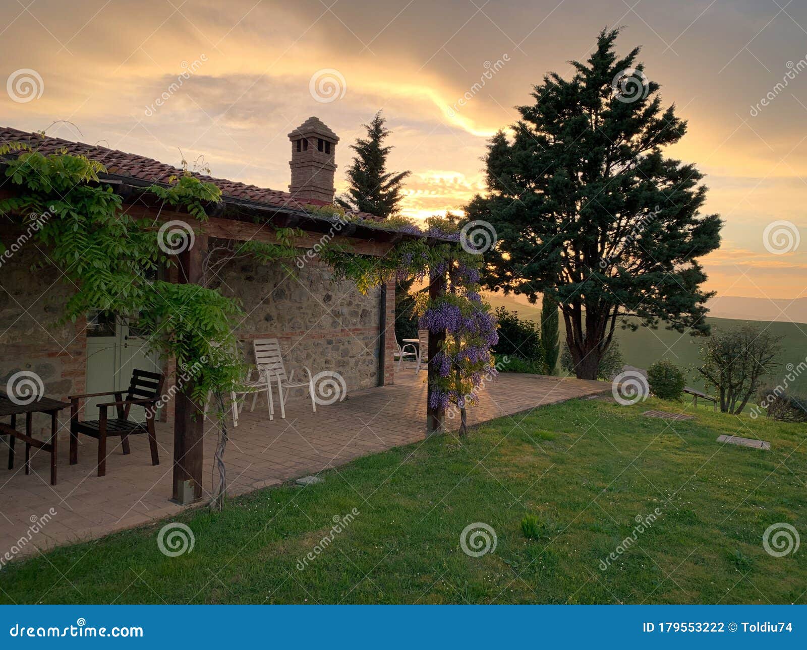 Stone Cottage with Patio at Sunset Stock Photo - Image of veranda ...