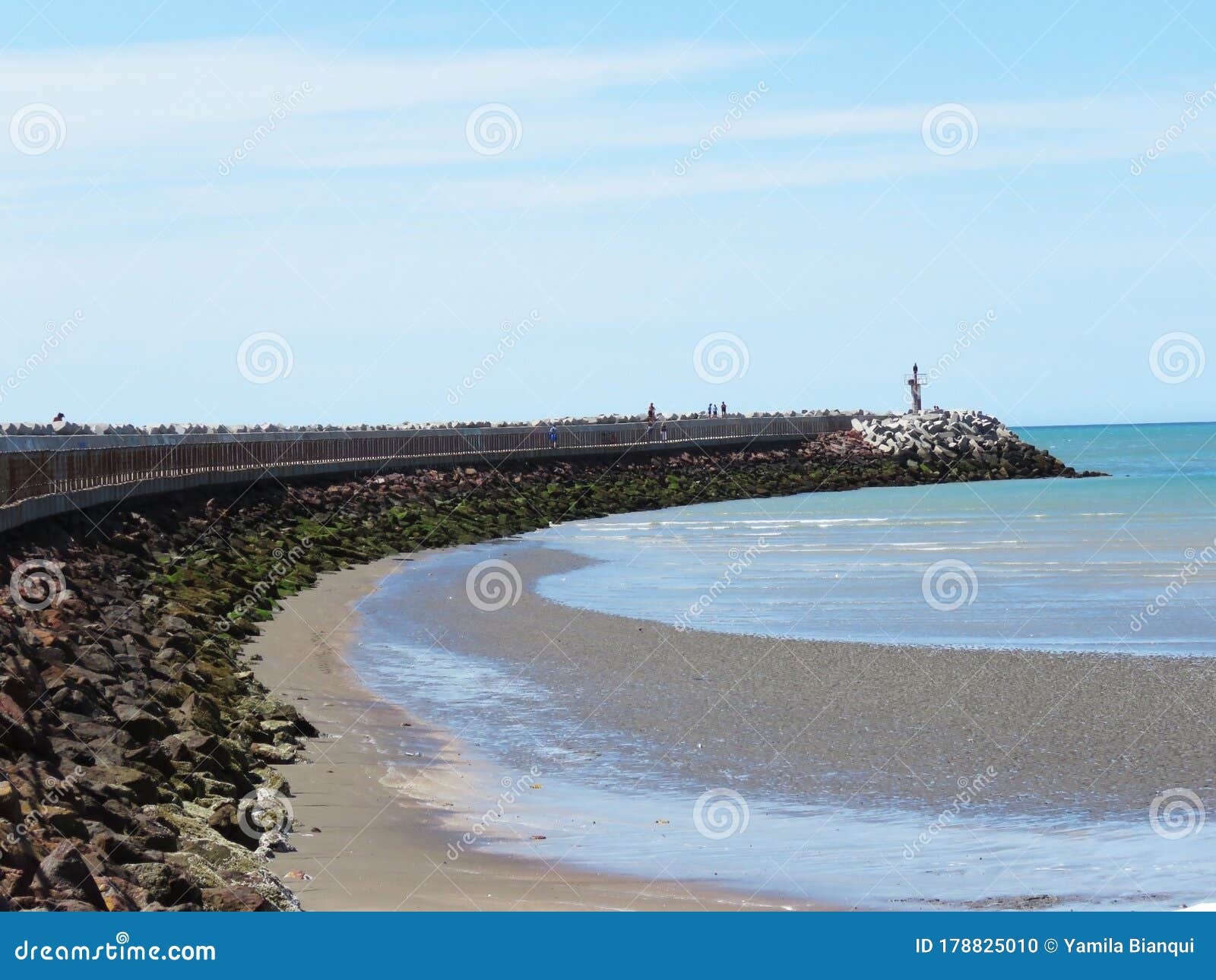 Stone Cove With The Lighthouse At The End In The Ocean Stock ...