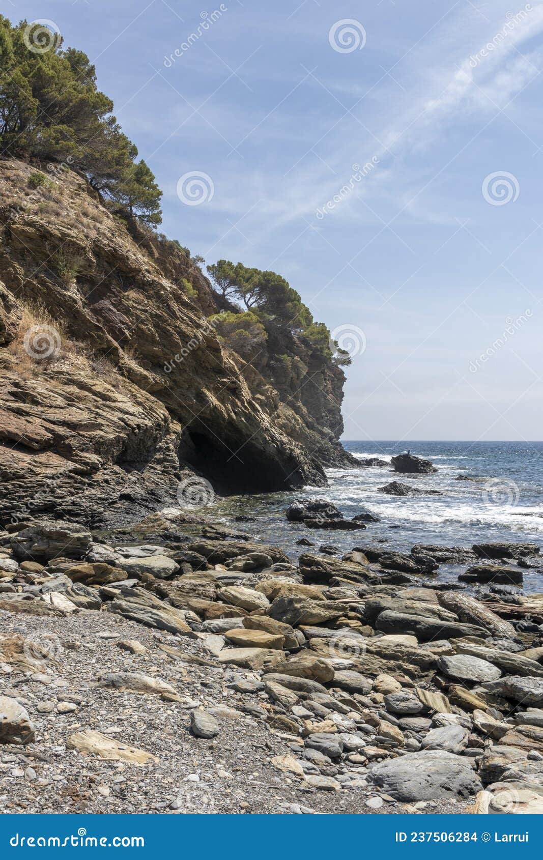 Stone Cove With The Lighthouse At The End In The Ocean Stock ...