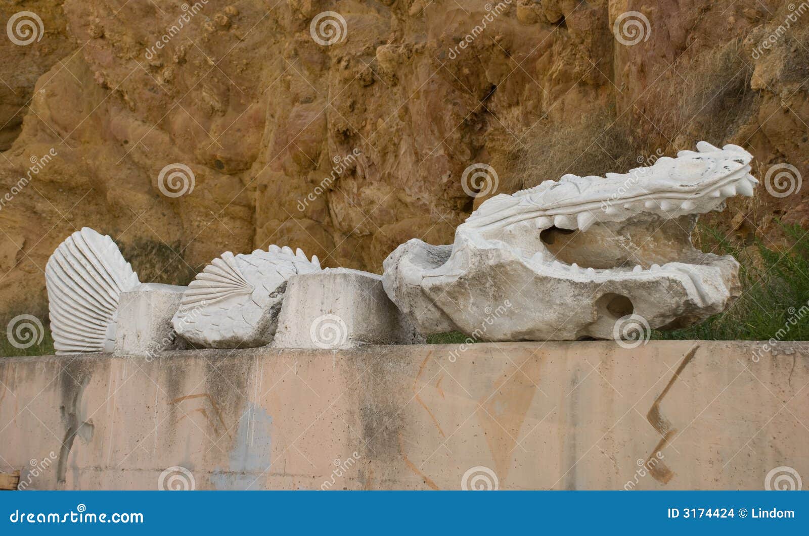 Stone Crocodile With Wide Open Mouth And Huge Teeth Next To Violet ...