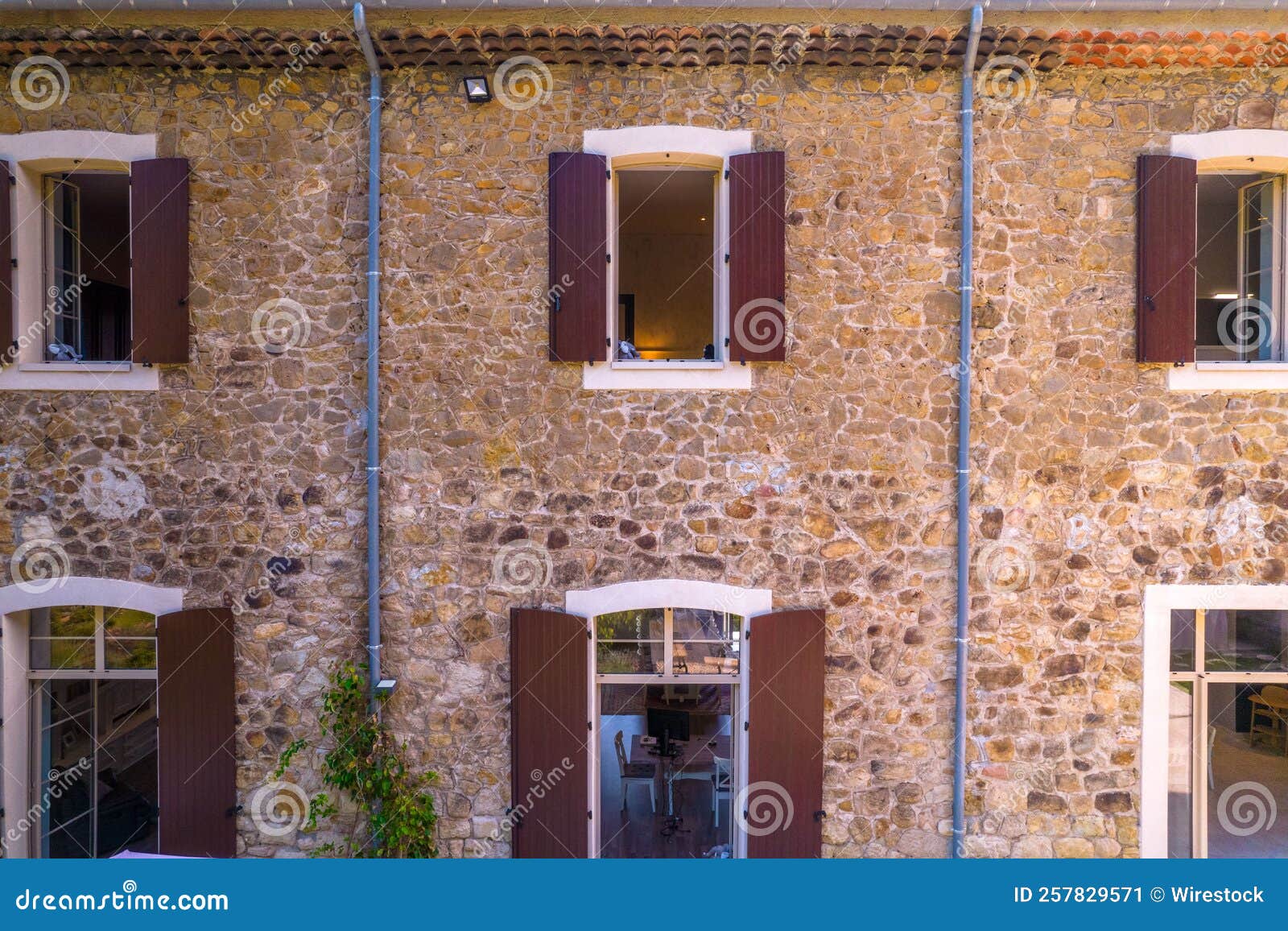 Stone Facade of a Large House with Six Open Windows on Two Floors, Two ...