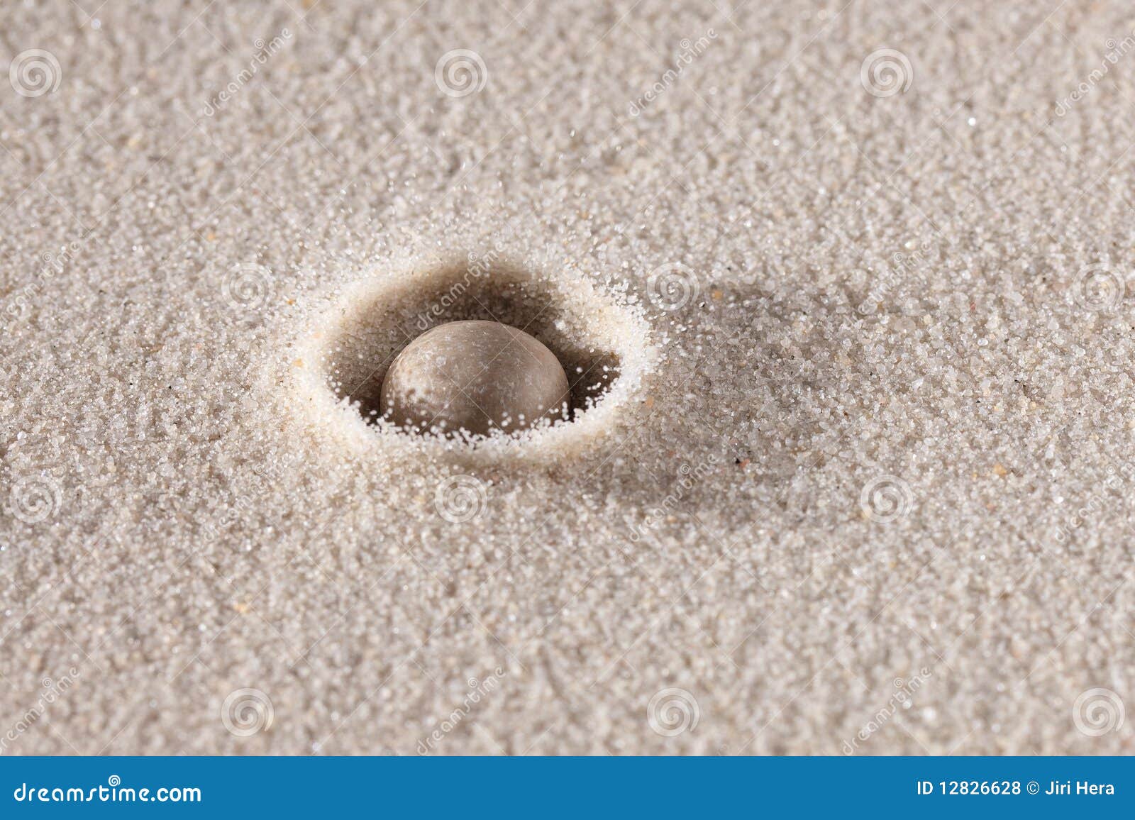 Stone falling down in sand stock photo. Image of round - 12826628