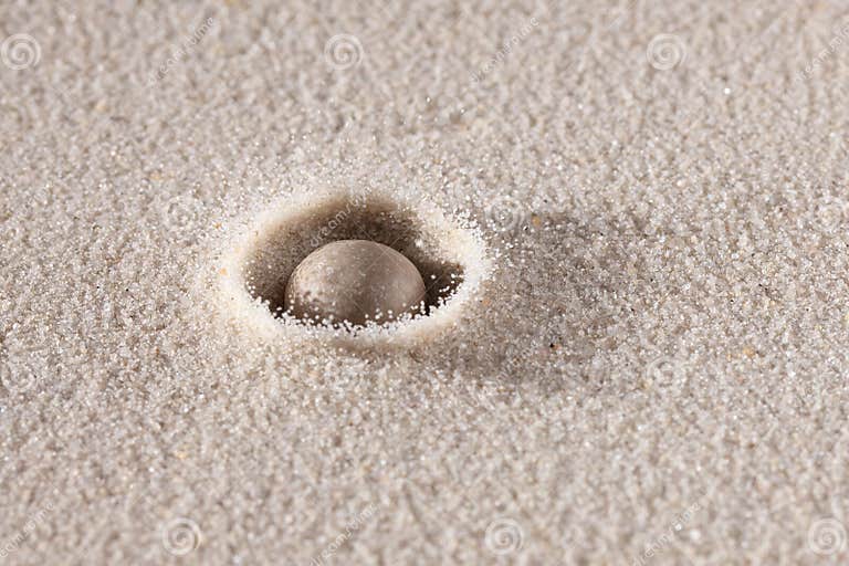 Stone falling down in sand stock photo. Image of round - 12826628