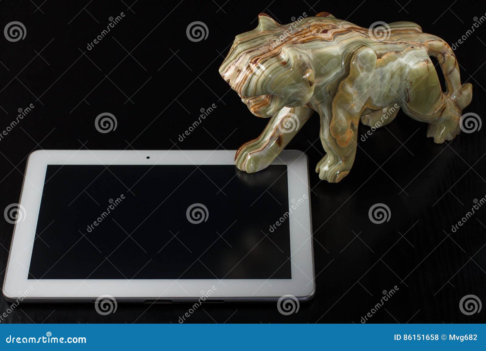 Stone Figure of a Tiger and the Tablet Stock Photo - Image of computer ...