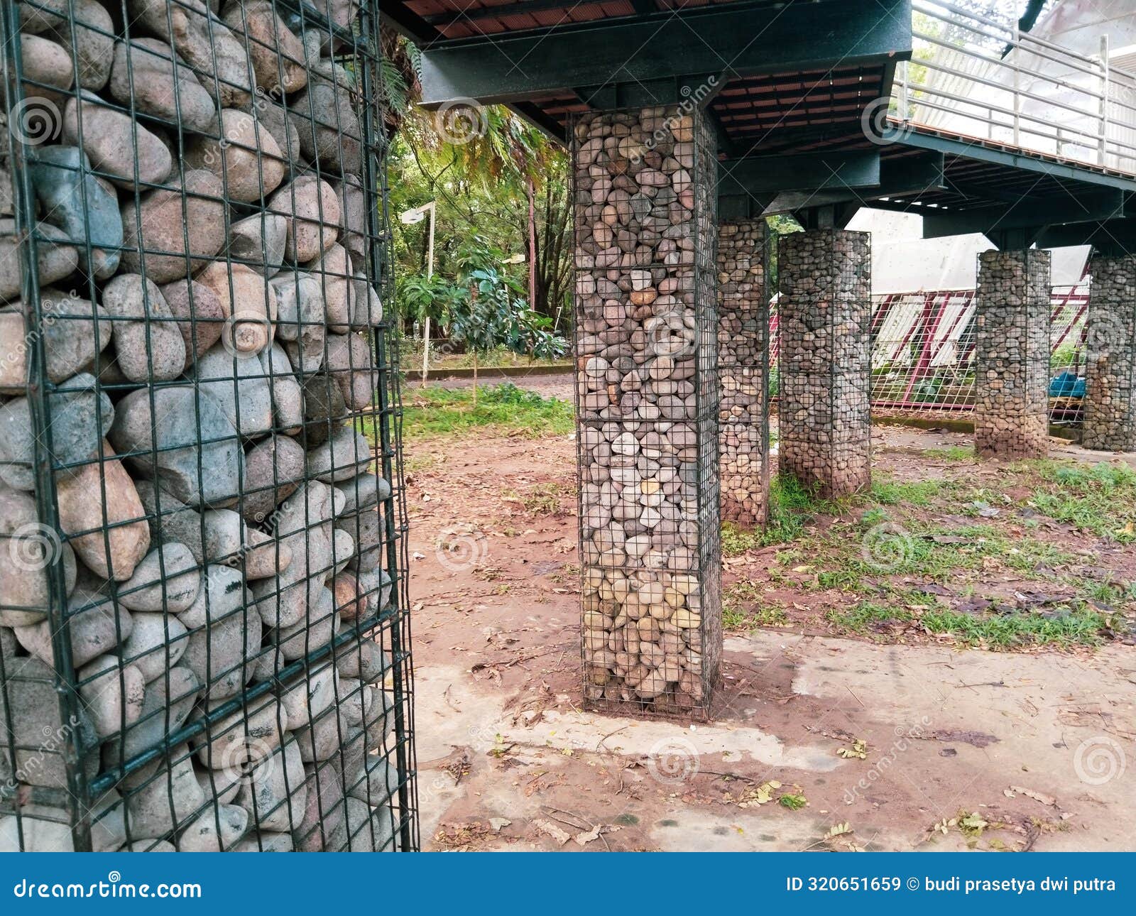 Stone-filled Pillars Supporting a Bridge or Structure, Set in a Grassy ...