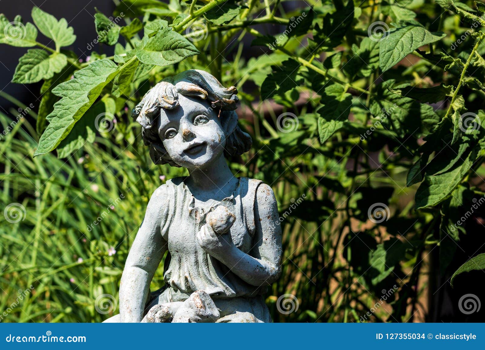 Stone Garden Statue Placed in a Tomato Patch Stock Photo - Image of ...