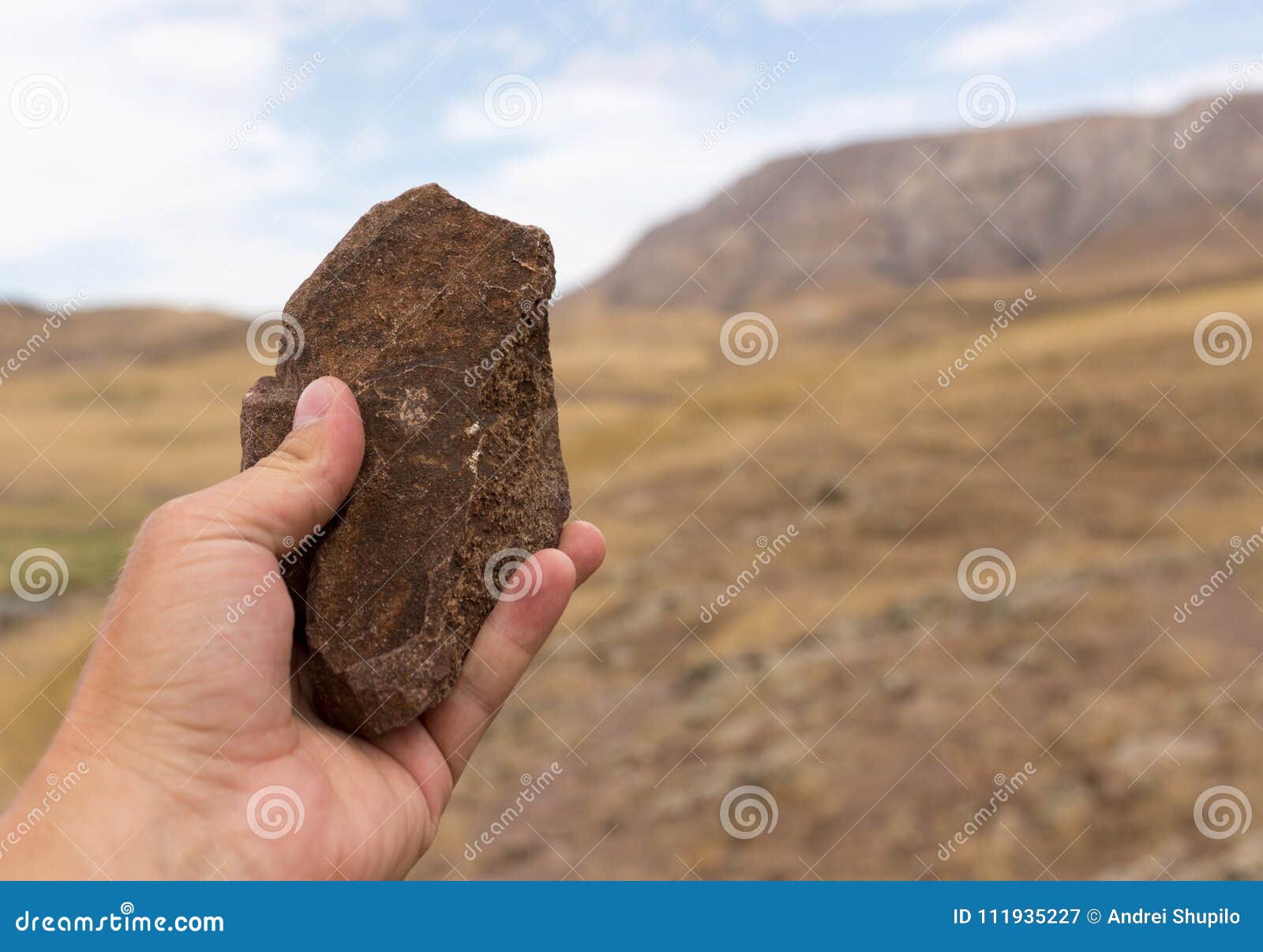 Stone in hand on nature stock image. Image of white - 111935227