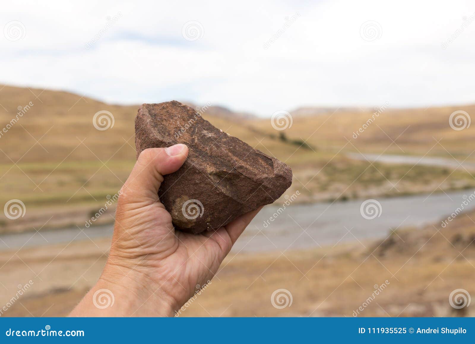 Stone in hand on nature stock image. Image of fingers - 111935525