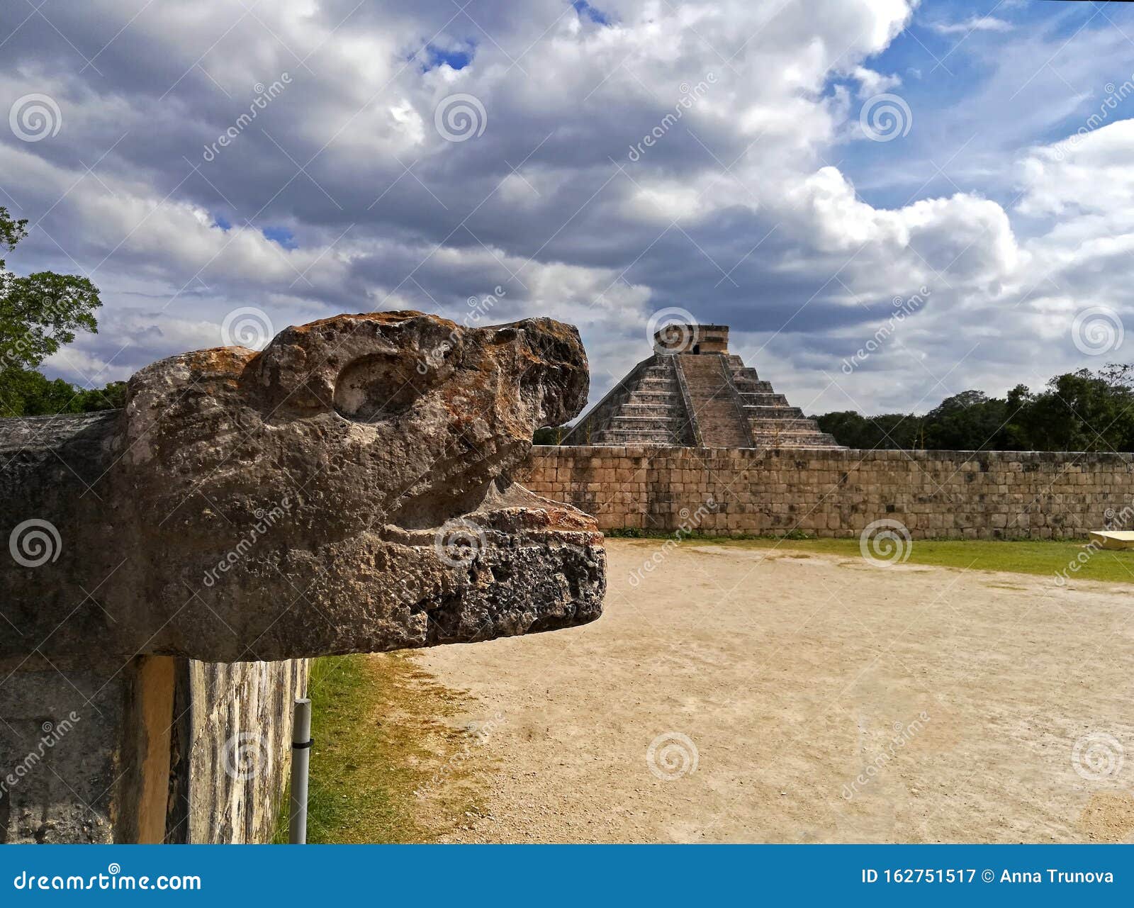 The Stone Head of a Feathered Serpent and the Pyramid of Kukulkan in ...