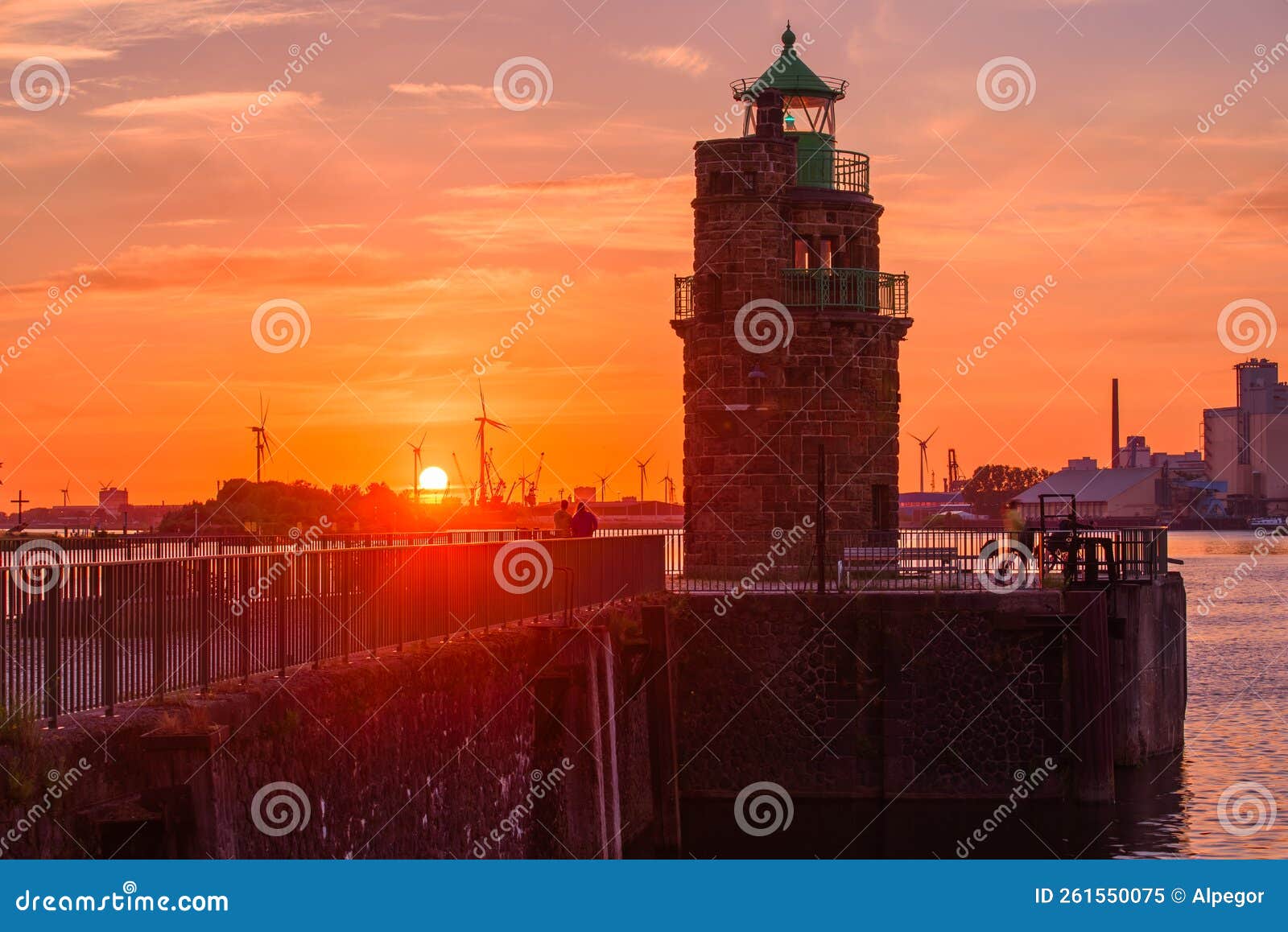 Stone Lighthouse Overlooking a Commercial Harbour at Sunset Stock Image ...