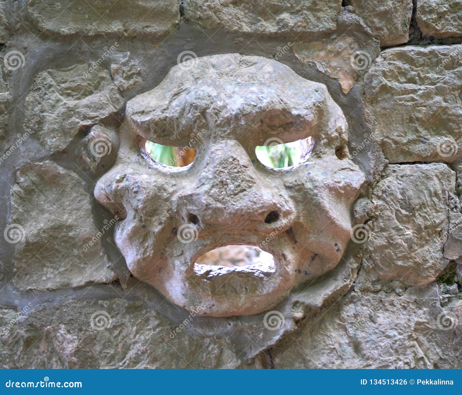 Stone mask in the wall stock photo. Image of terrific - 134513426