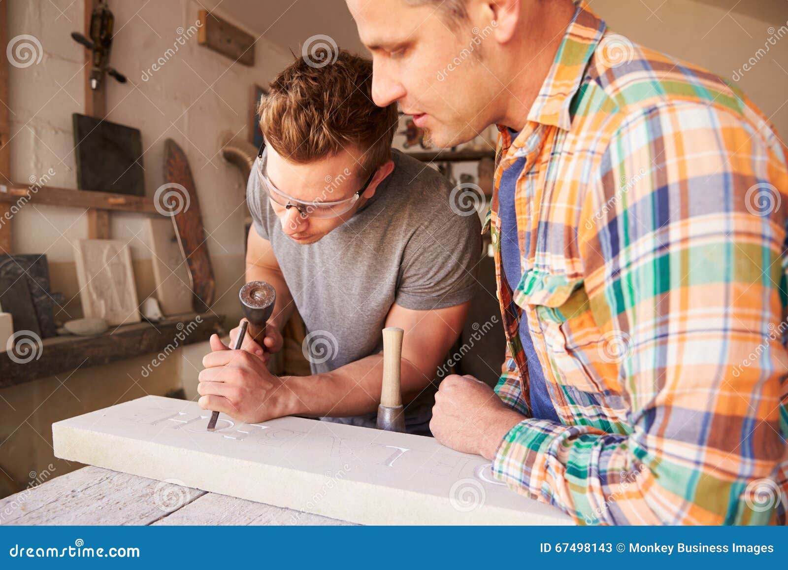 Stone Mason with Apprentice at Work on Carving in Studio Stock Image ...