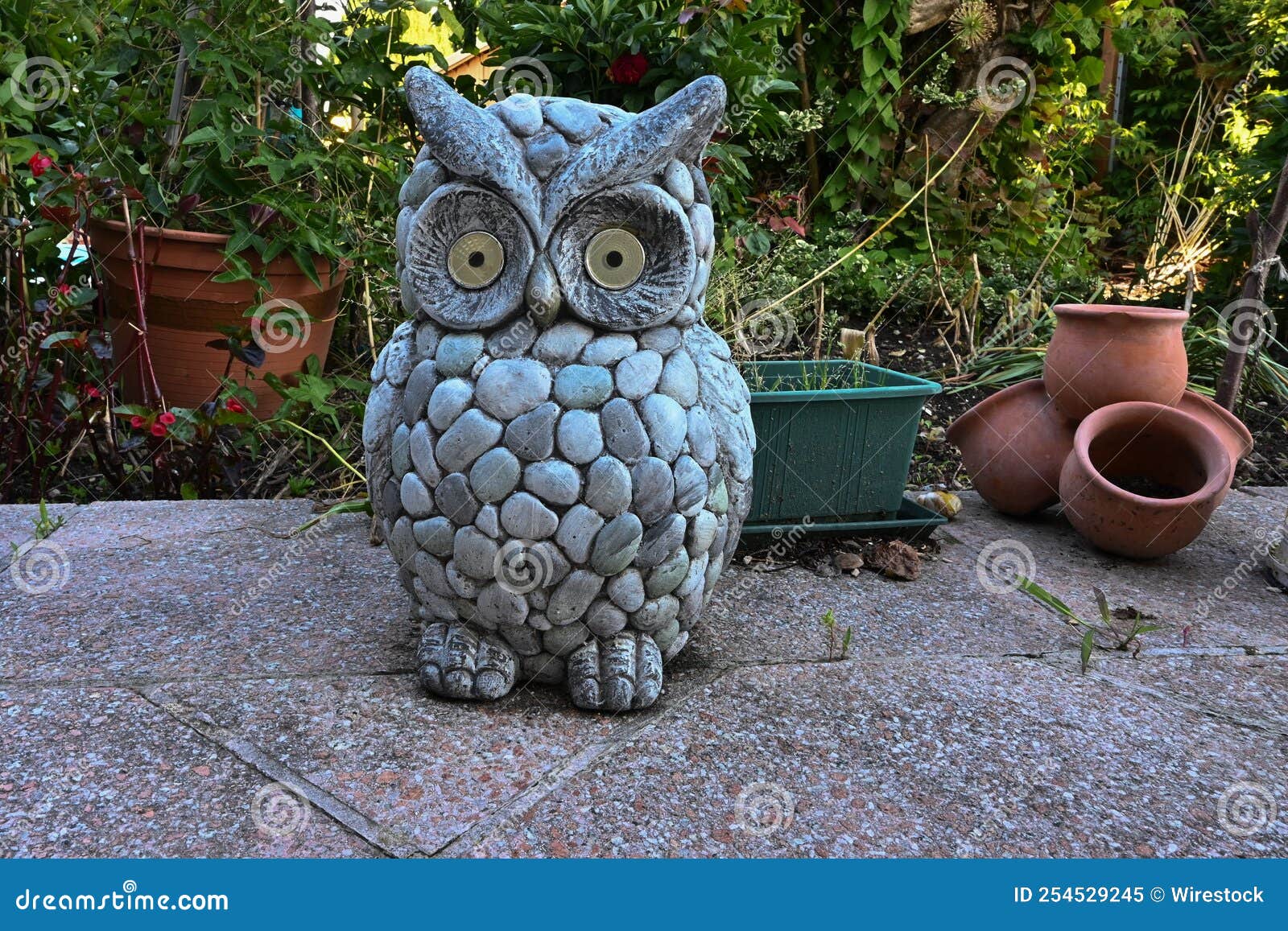 Stone Owl Figure on a Concrete Surface in a Garden Stock Image - Image ...