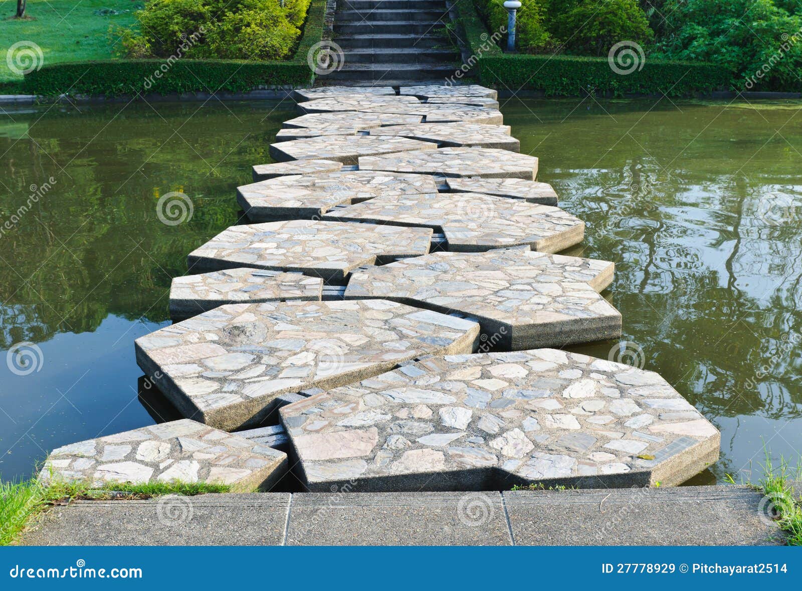 Stone path across the pond stock image. Image of plant - 27778929