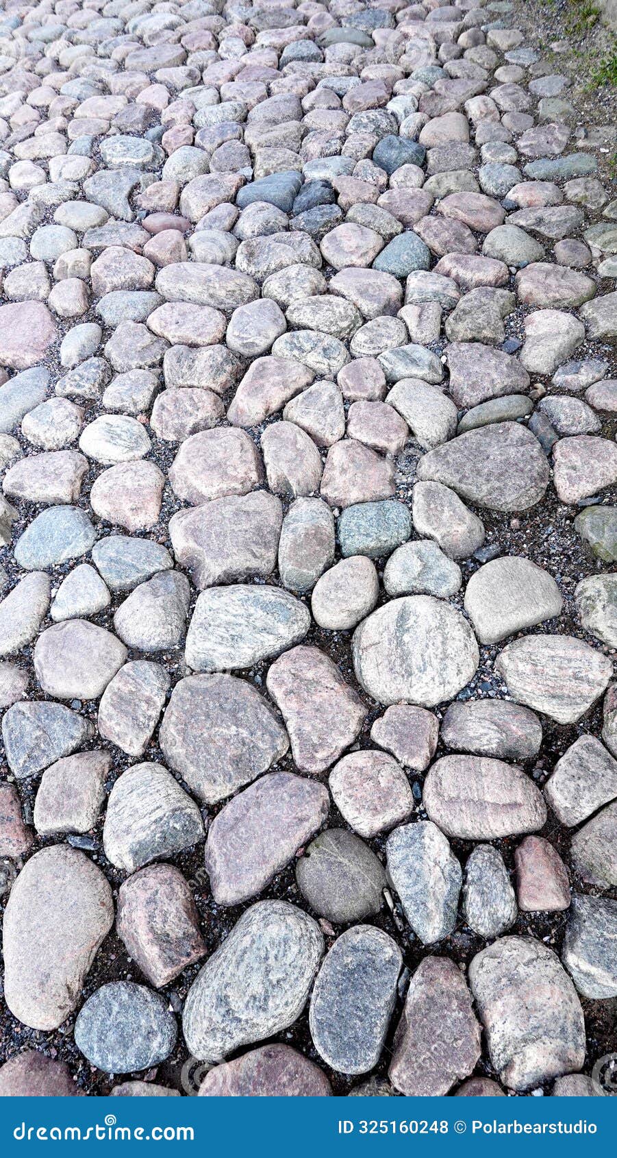 An Old Stoneblock Pavement Cobbled With V-shaped Concrete Slabs With ...