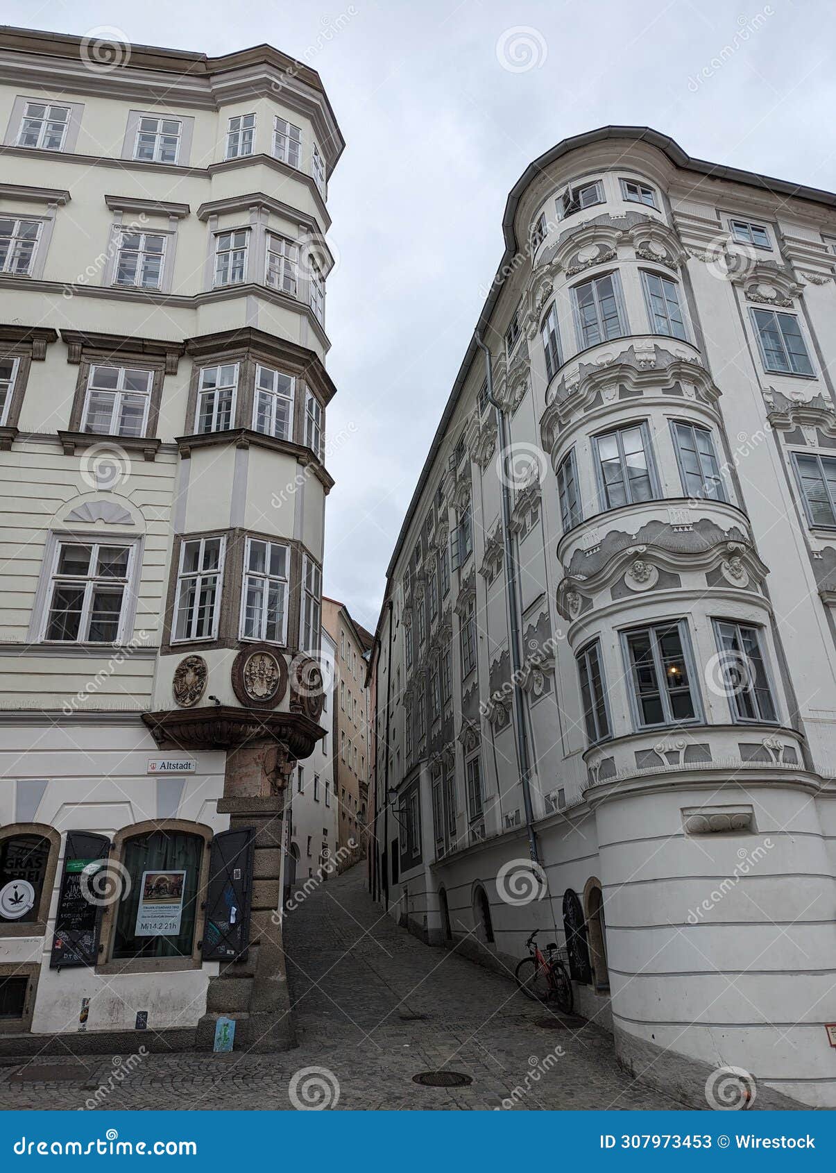 Stone Pathway between Two White Buildings, Adorned with Windows and a ...