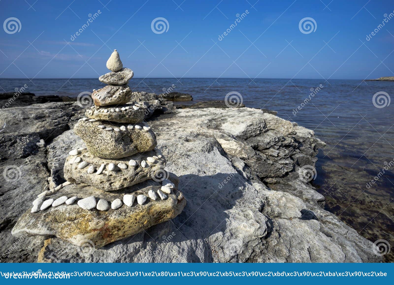 Stone pyramid on the beach stock photo. Image of beach - 56562546