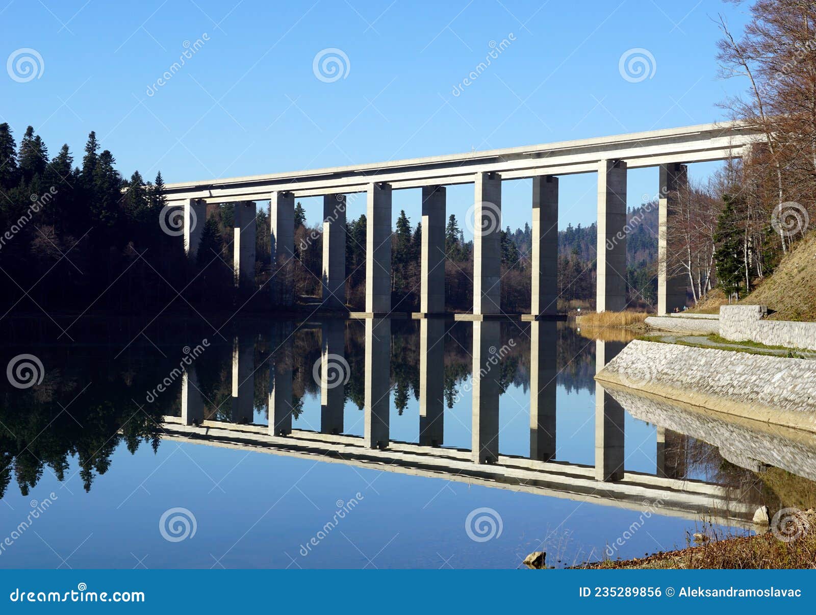 Stone Road Overpass Over the Lake and Reflections in the Water Stock ...