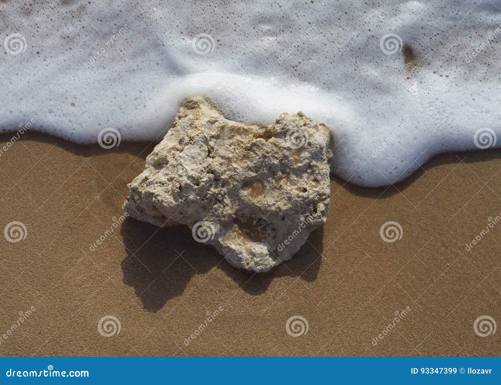 Stone in the Sand and a Wave Stock Image - Image of wave, surf: 93347399