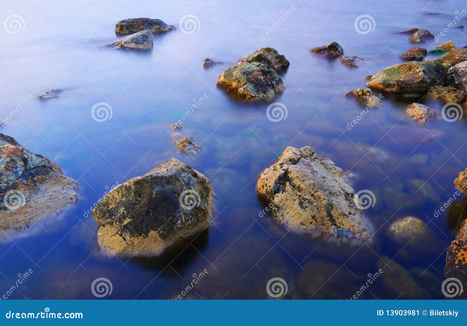 Stone in sea stock image. Image of boulder, color, cloud - 13903981