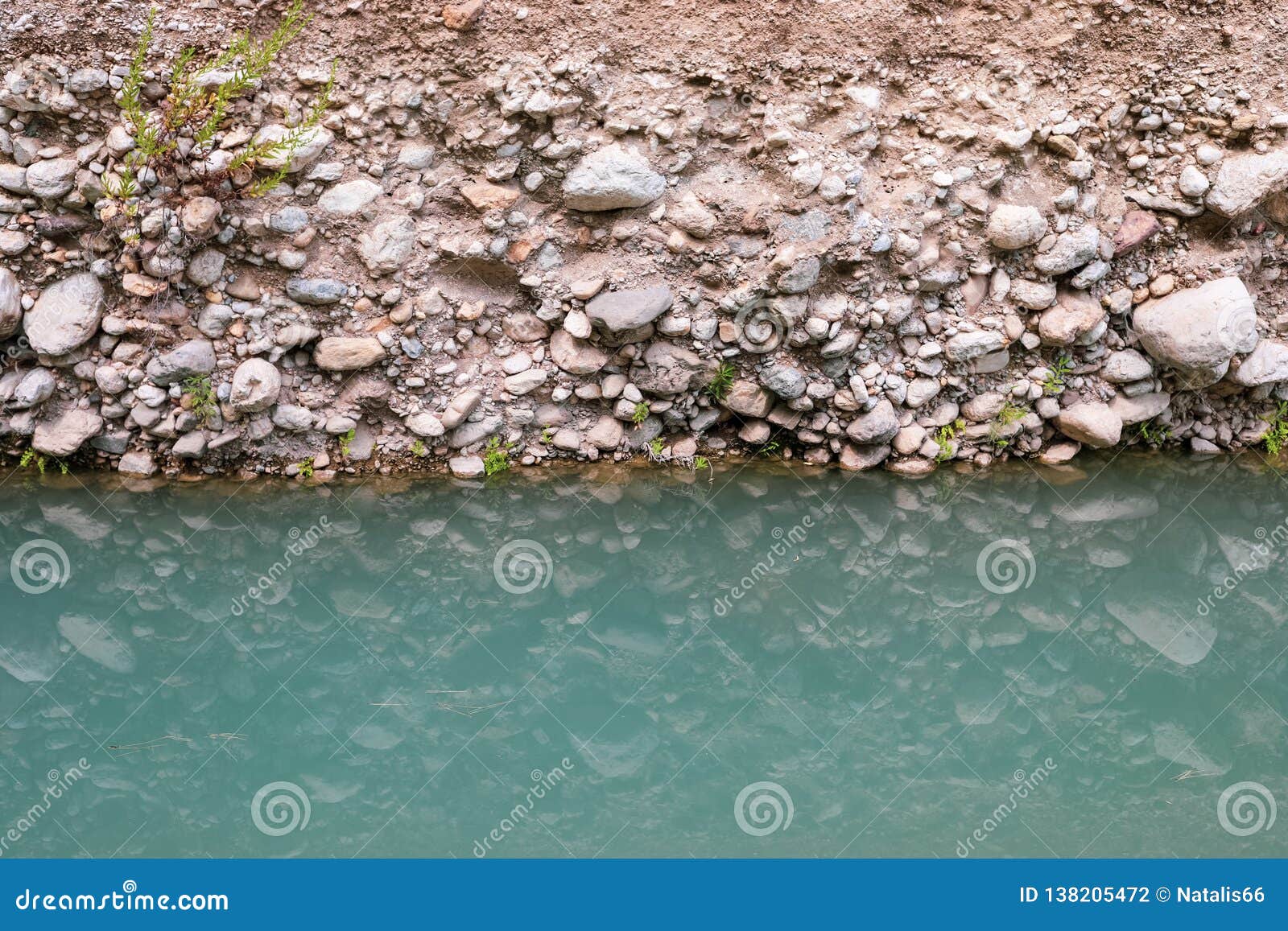 Stone Shore of River and Its Reflection in Turquoise Water Surface ...