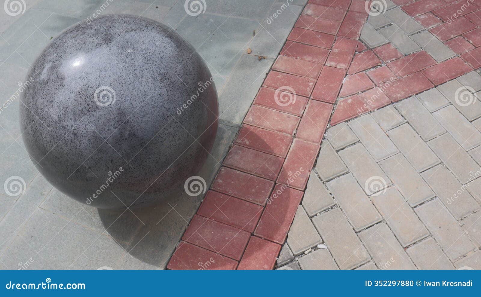 Stone Sphere on a Patterned Pavement Design Stock Photo - Image of ...
