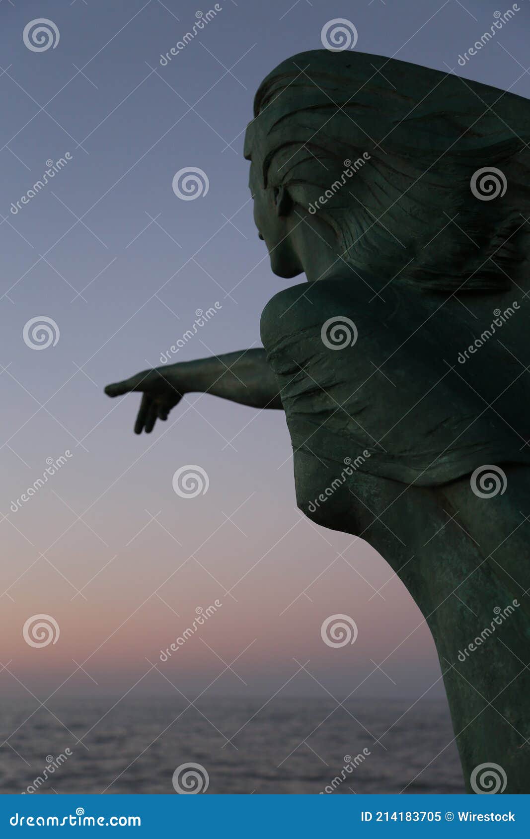 Stone Statue Pointing at the Horizon at Sunset Stock Image - Image of ...