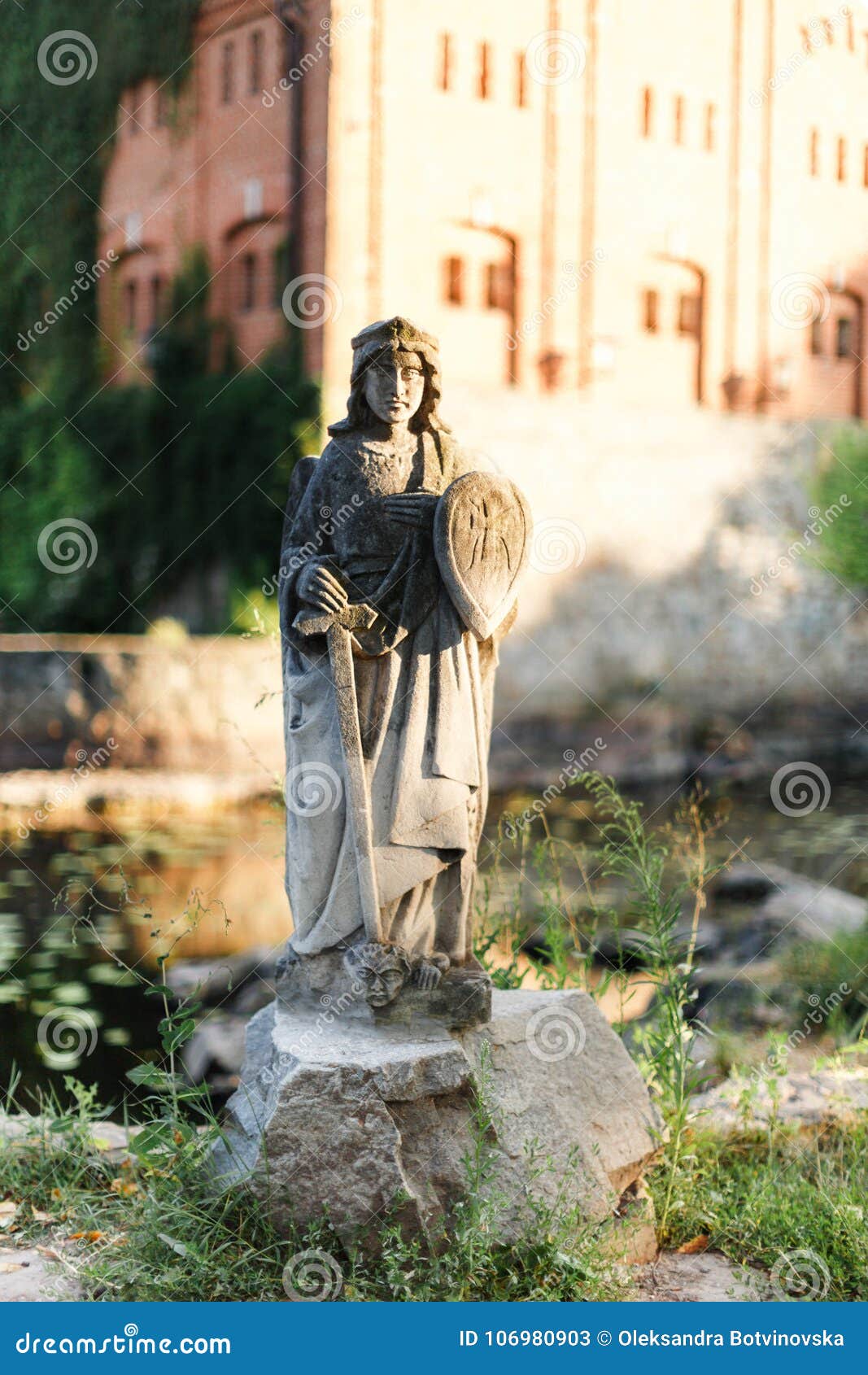 Stone Statue with Sword and Shield on a Stone Stock Image - Image of ...