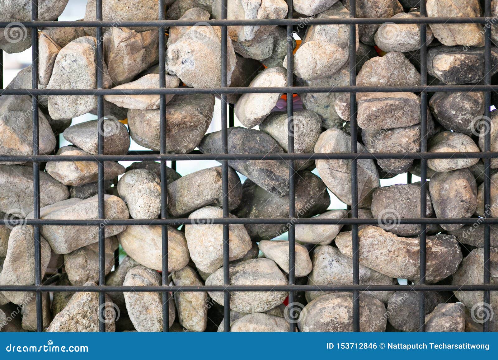 Stone in a steel cage stock photo. Image of texture - 153712846
