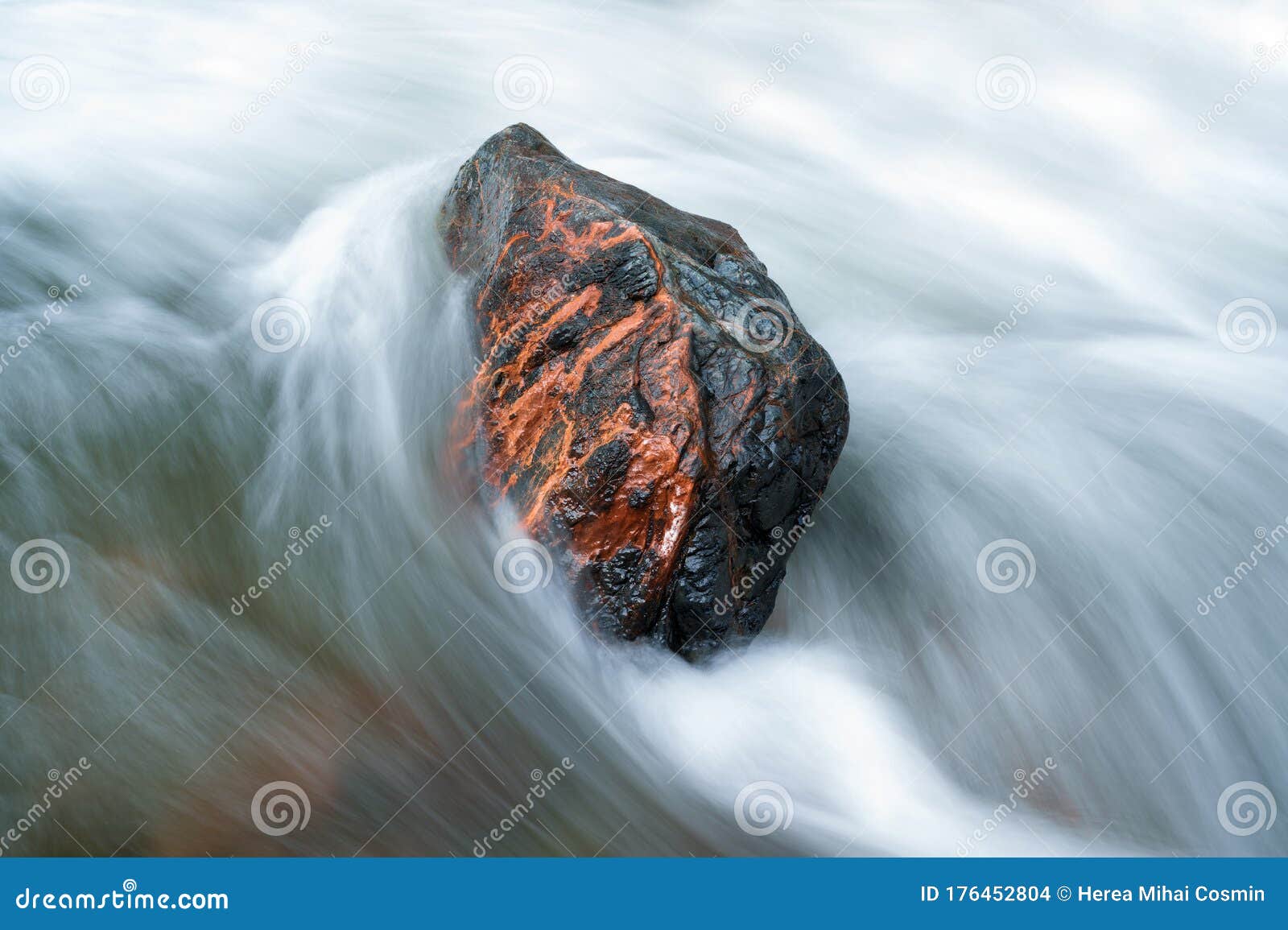 Stone in a Stream with Water Blurred by Long Exposure Stock Photo ...
