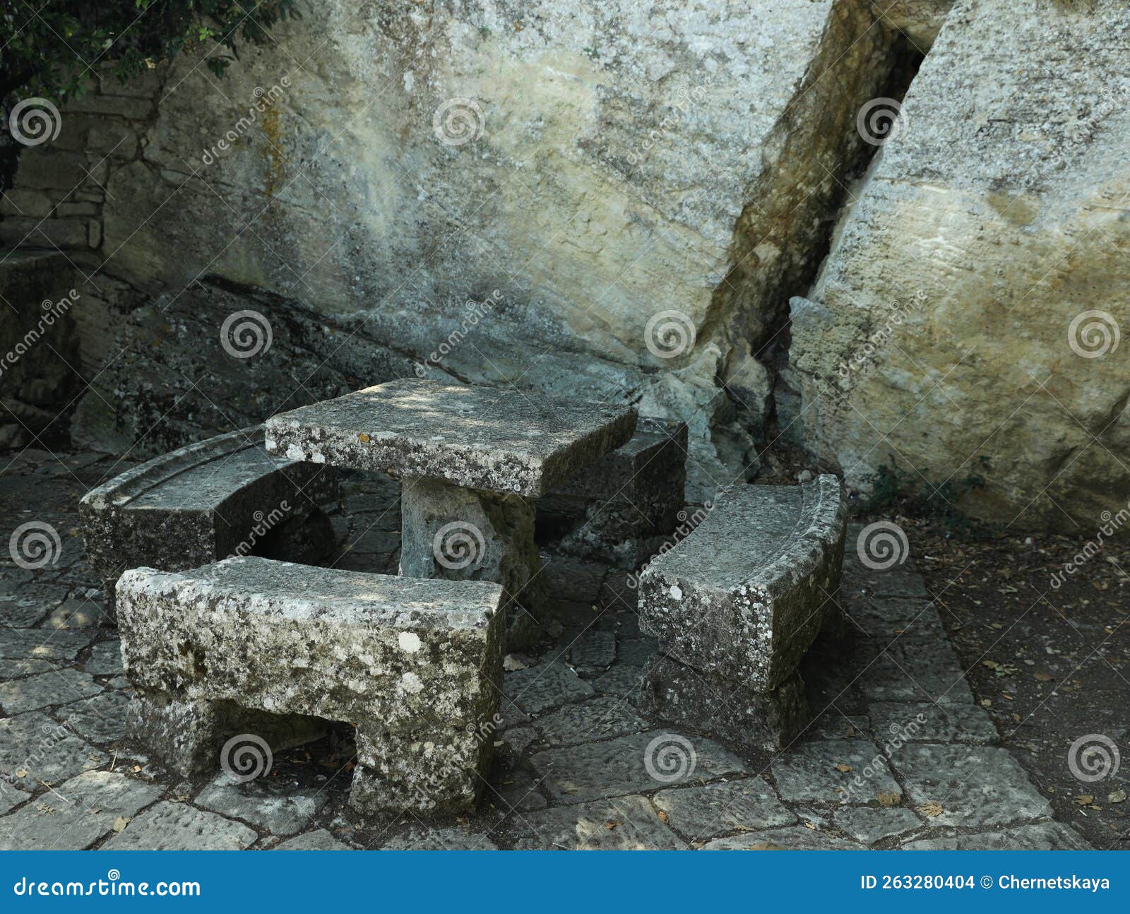 Stone Table and Benches Near Rock Outdoors Stock Photo - Image of ...