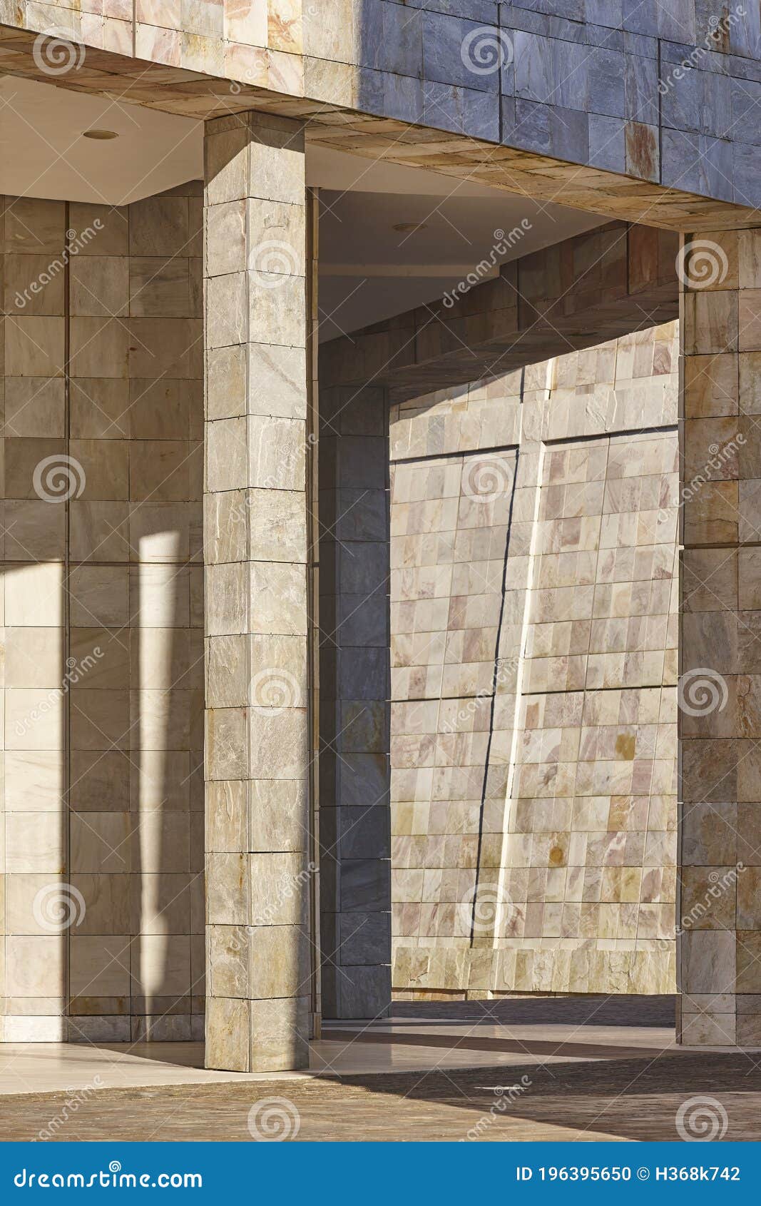 Stone Tiles Building Facade with Columns. Architecture and Construction ...