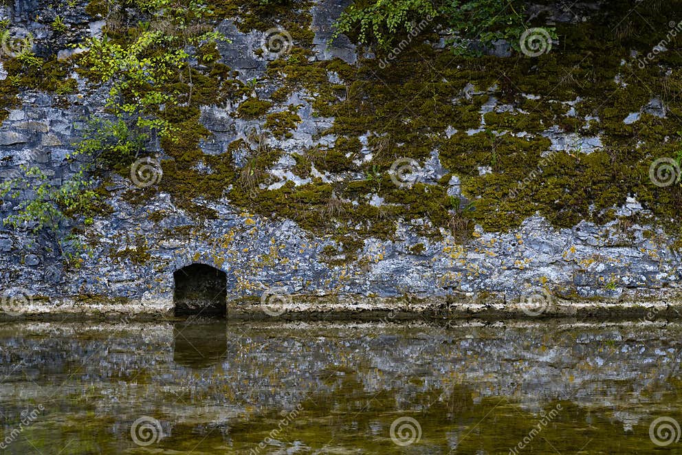 The Stone Wall of an Ancient Castle in Front of a Moat with Water is ...