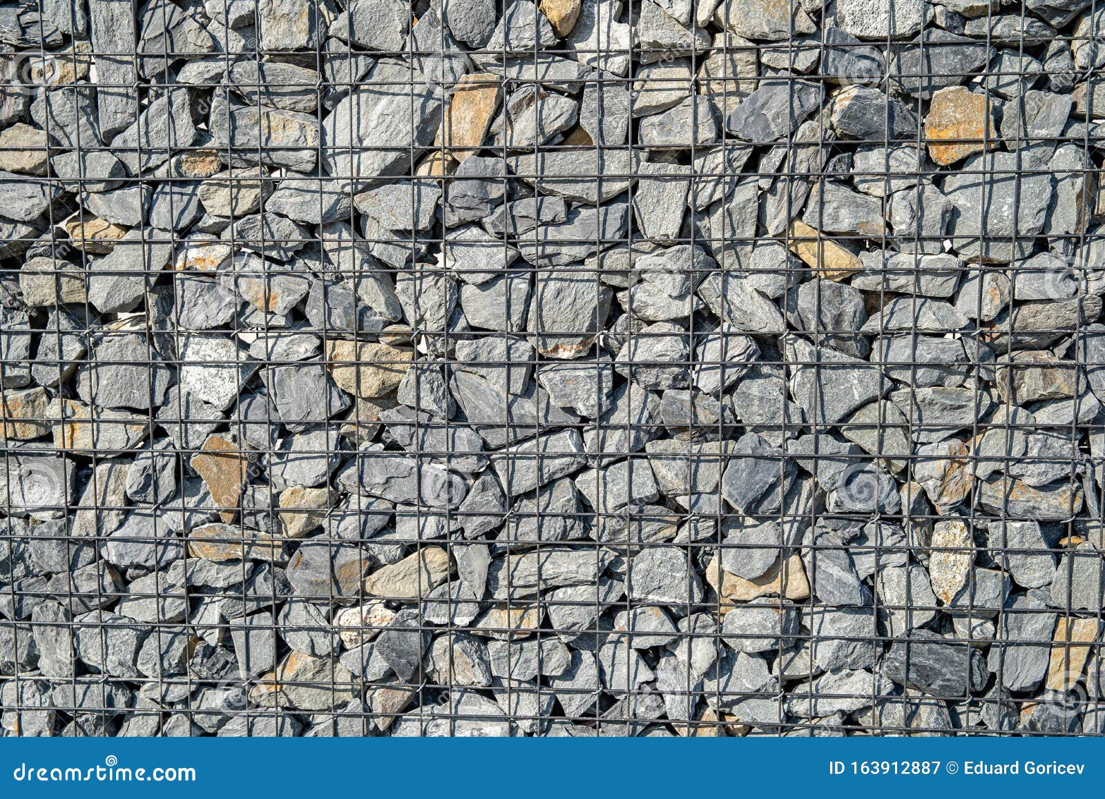Stone Wall Background. Modern Wall Made of Stone in a Wire Case Stock ...