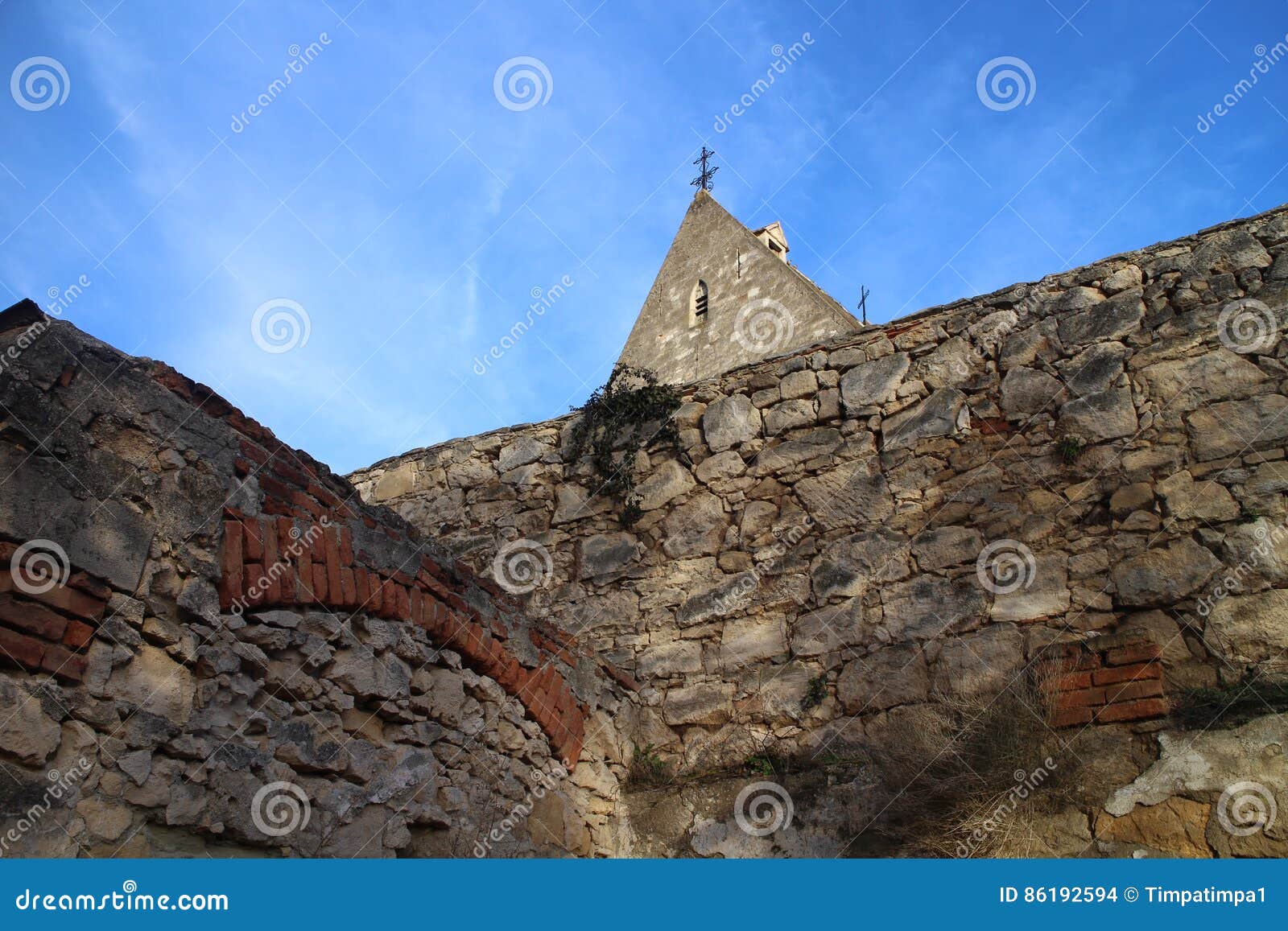 Stone Wall with Church in Rust Stock Photo - Image of cross, rust: 86192594