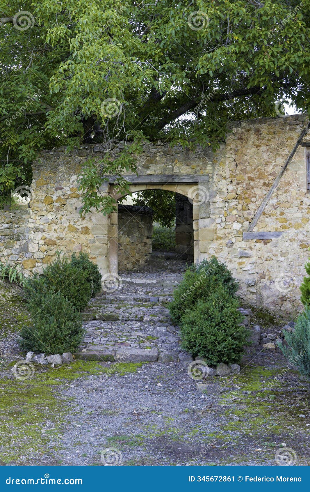 A Stone Wall with a Door and a Path Leading To it Stock Image - Image ...