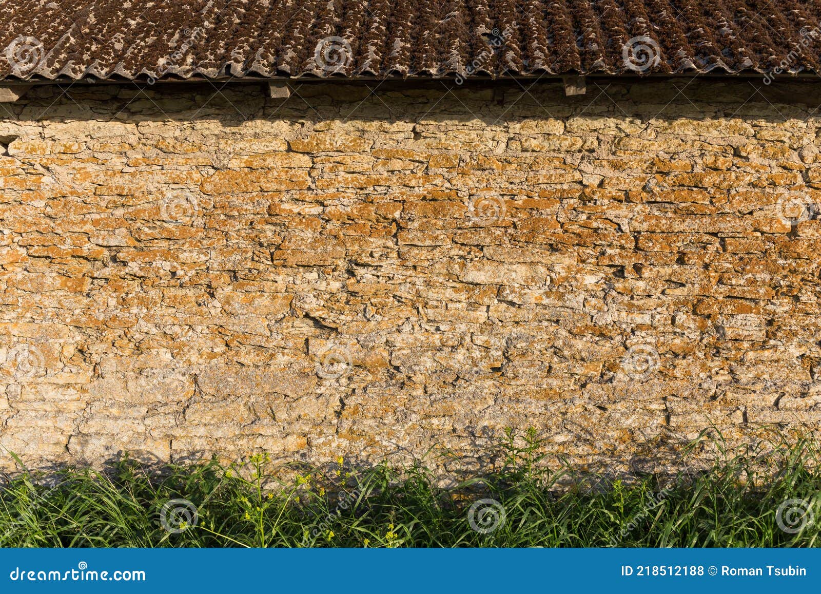 Stone wall with grass stock photo. Image of rocks, natural - 218512188