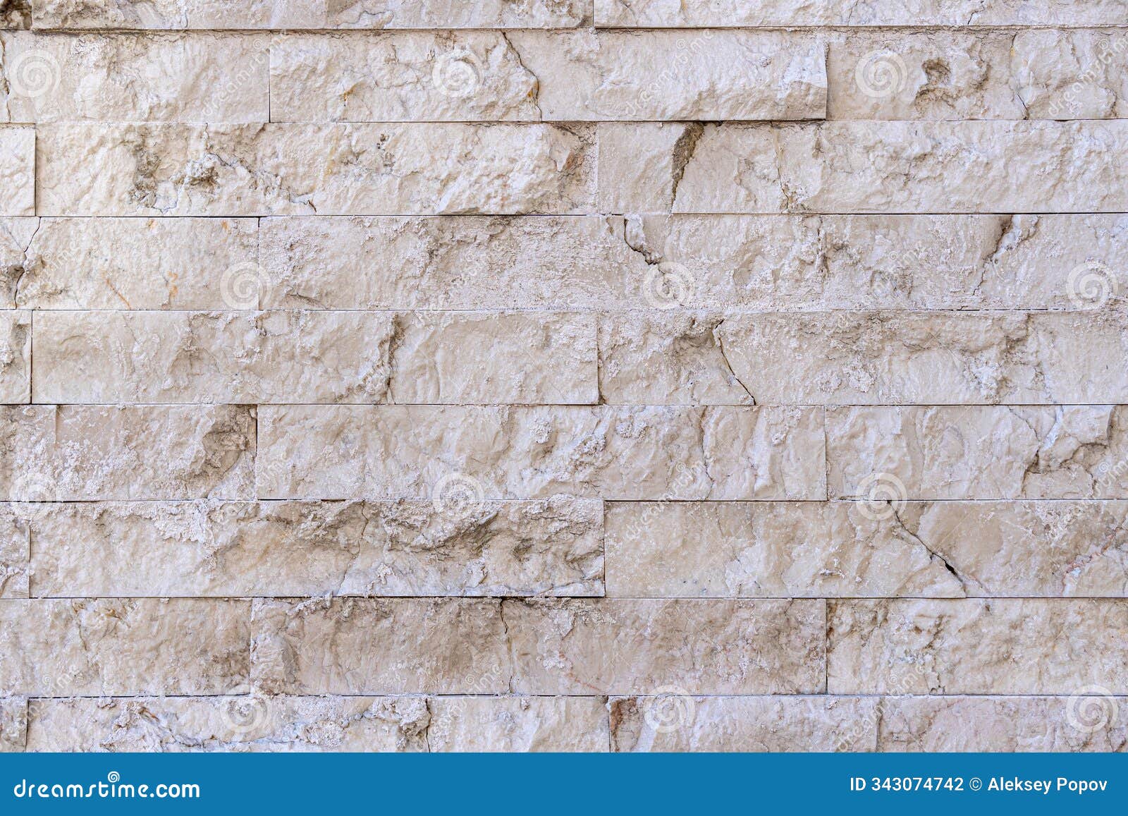 Stone Wall Made of Beige Tiles Arranged in a Staggered Pattern. Stock ...