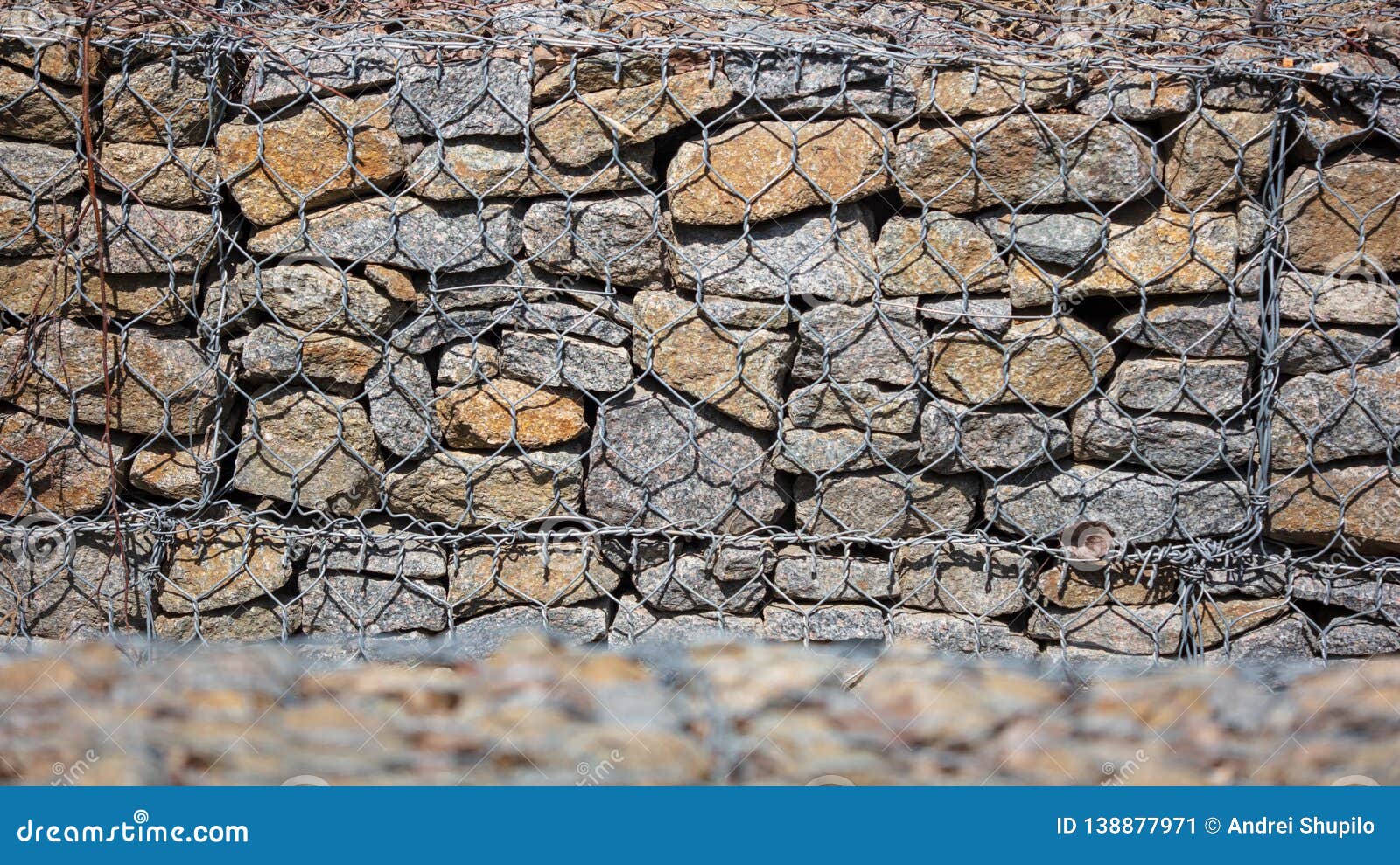 Stone Wall in a Metal Grid As a Background Stock Image - Image of ...