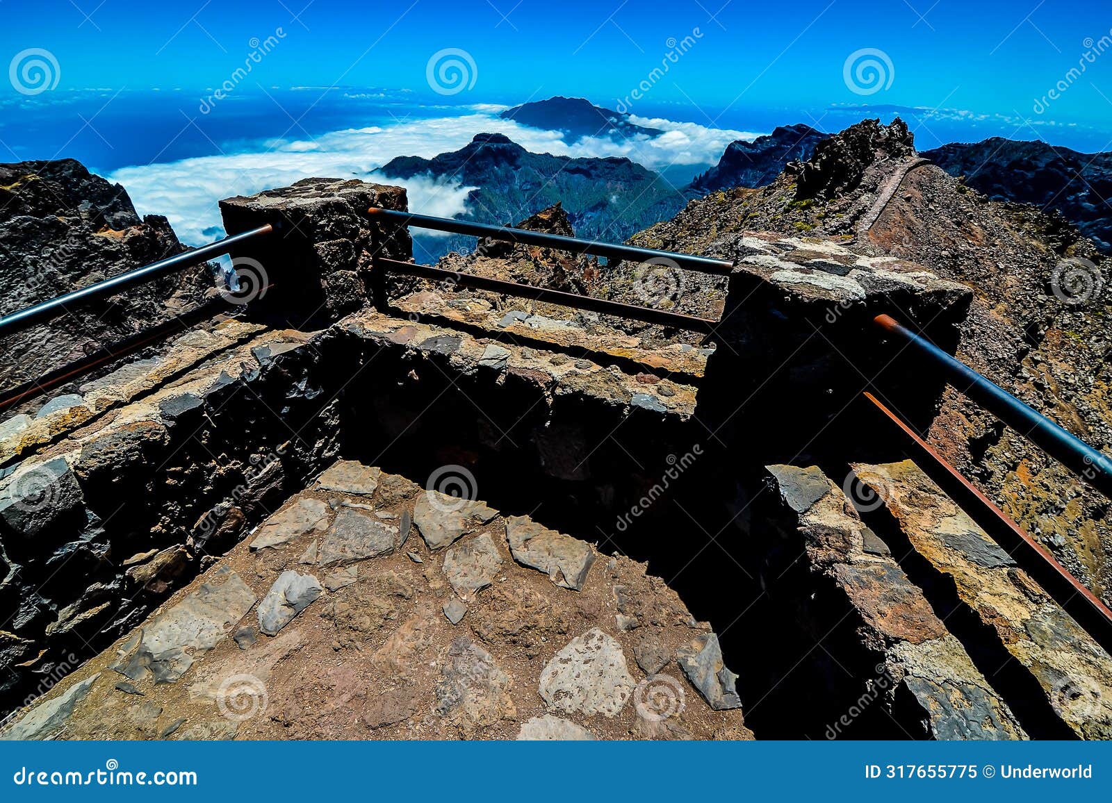 A Stone Wall with a Railing and a View of the Mountains Stock Image ...